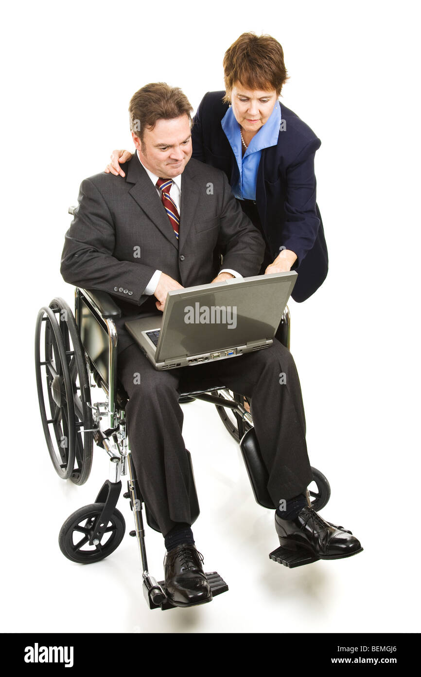Coworker helps a disabled man with his laptop computer. Full body ...