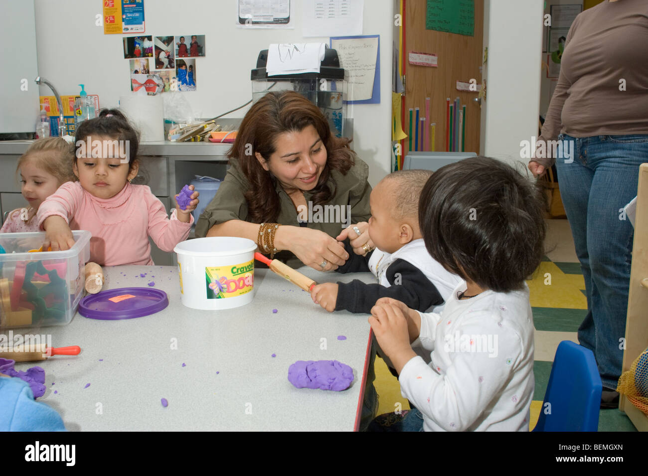 Preschool teacher with students in the classroom Stock Photo - Alamy