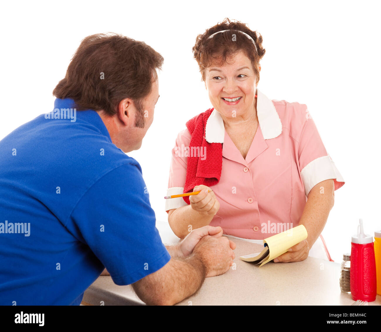 Friendly waitress taking a customer's order at a restaurant lunch ...