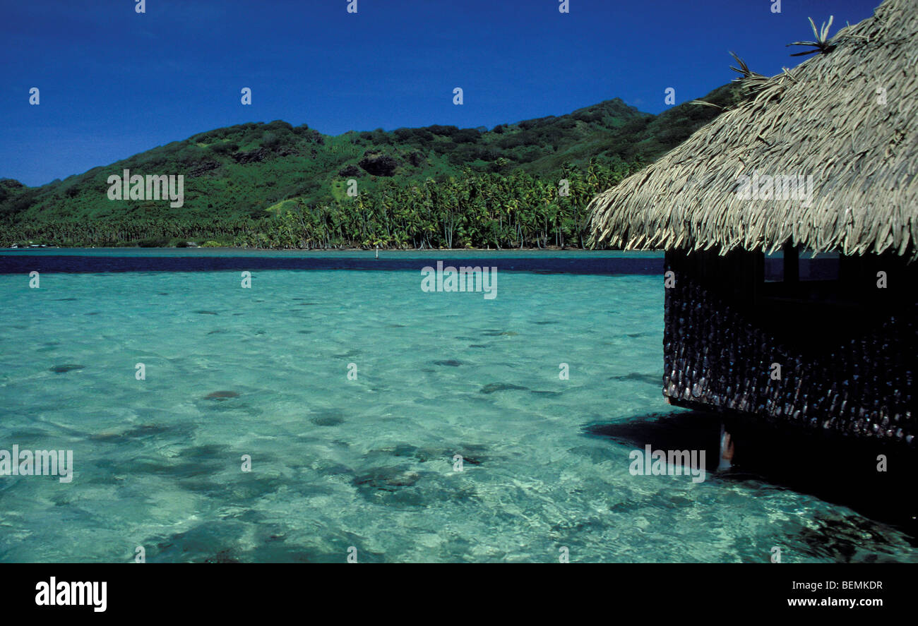 Small straw huts at coast, in South Pacific. Huahine. French Polynesia ...