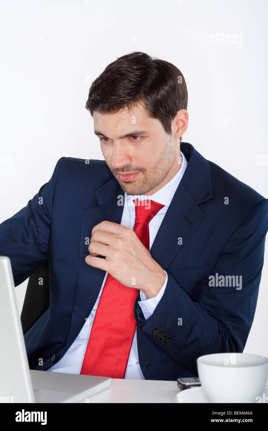 young business executive in suit behind desk with laptop Stock Photo ...