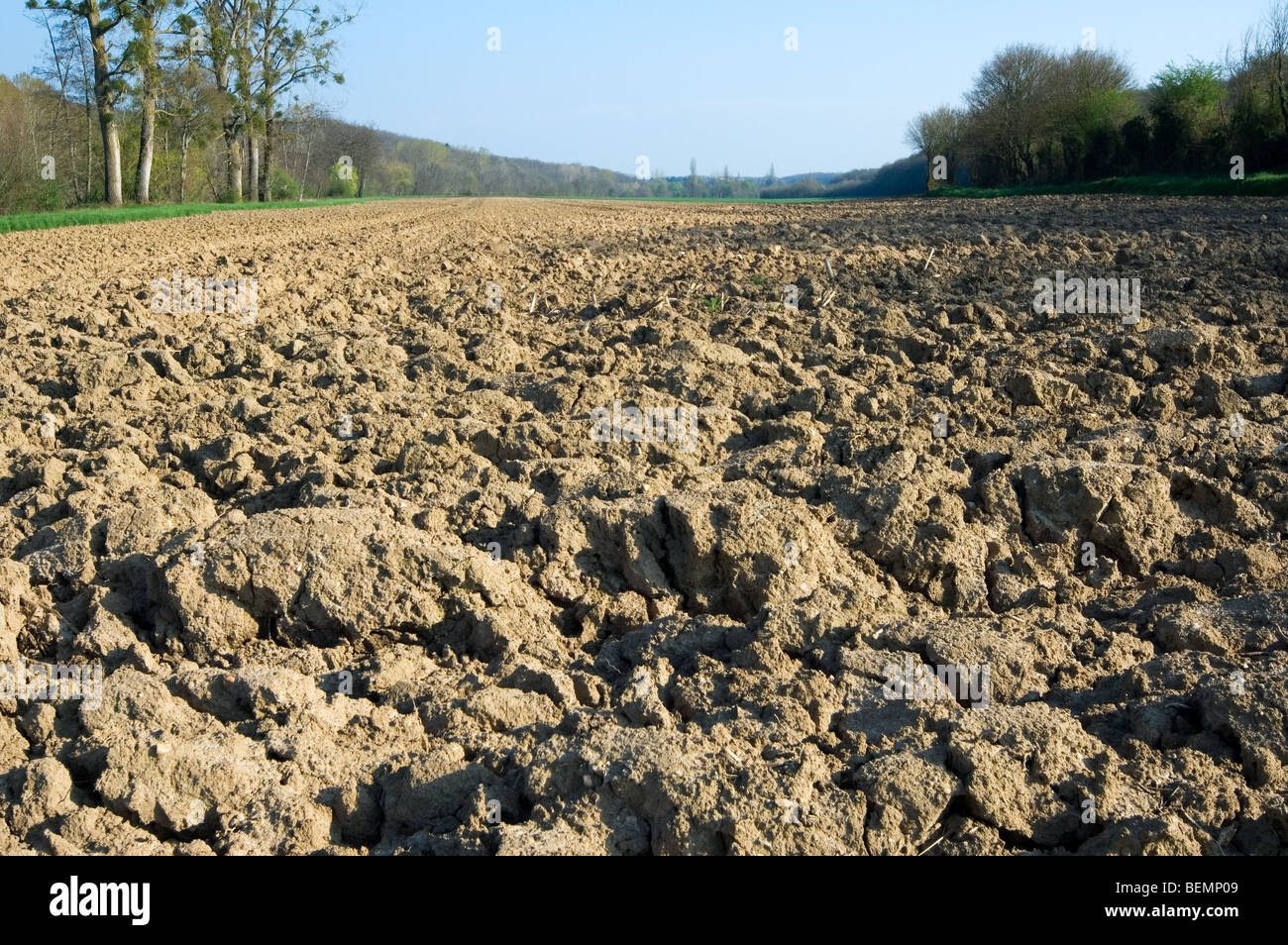 Farmland showing broken earth of ploughed field Stock Photo - Alamy