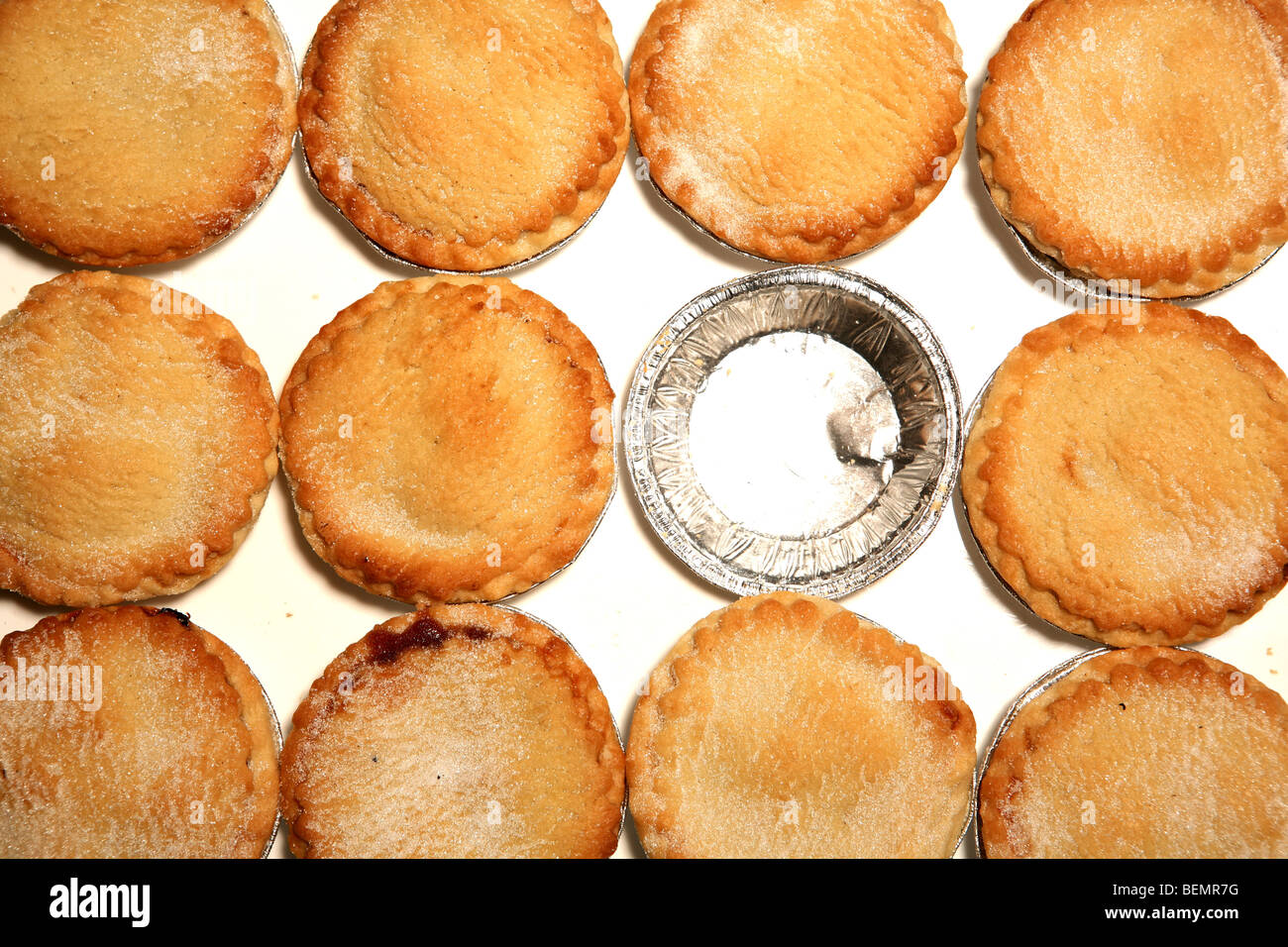 MInce pies surrounding an empty foil container for an already eaten ...