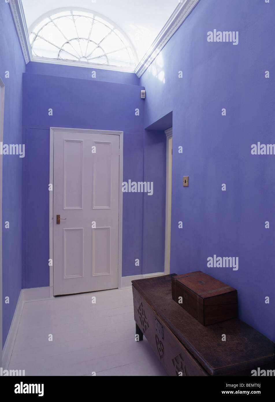 Bright blue traditional hall with white door and white carpet Stock ...