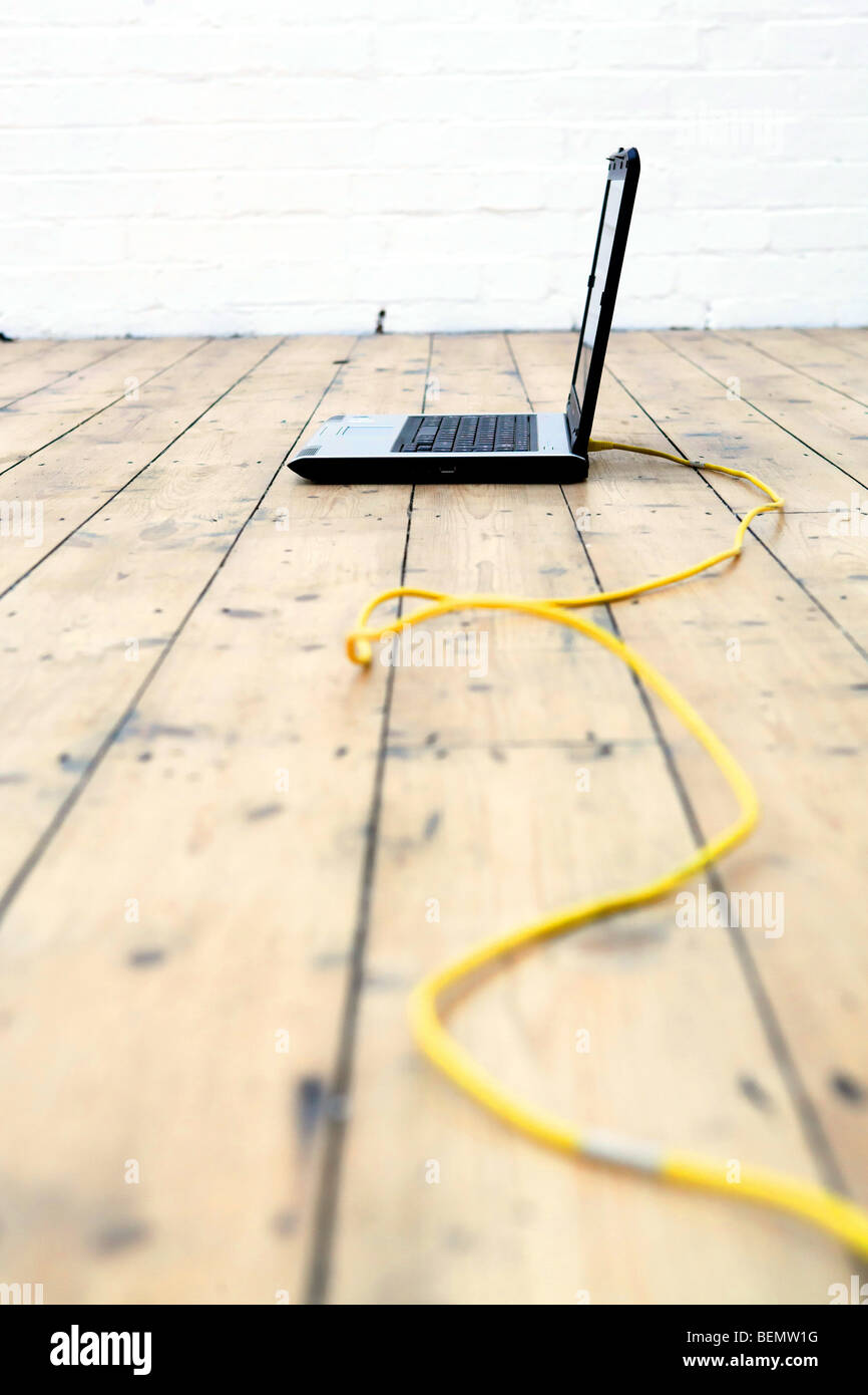 Laptop on wooden floor Stock Photo - Alamy