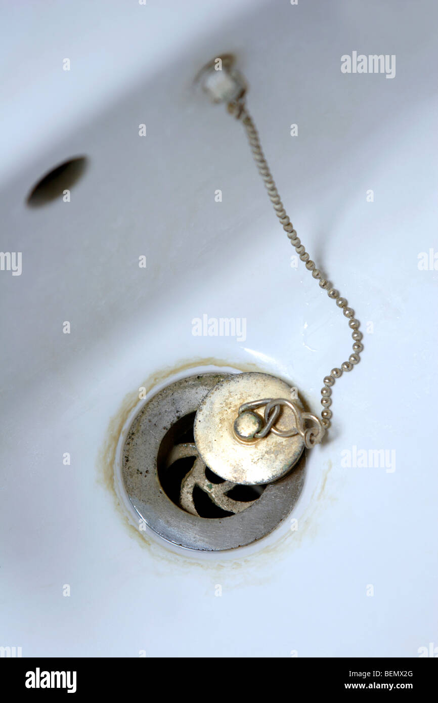 Empty bathroom sink with taps and plug close up Stock Photo - Alamy