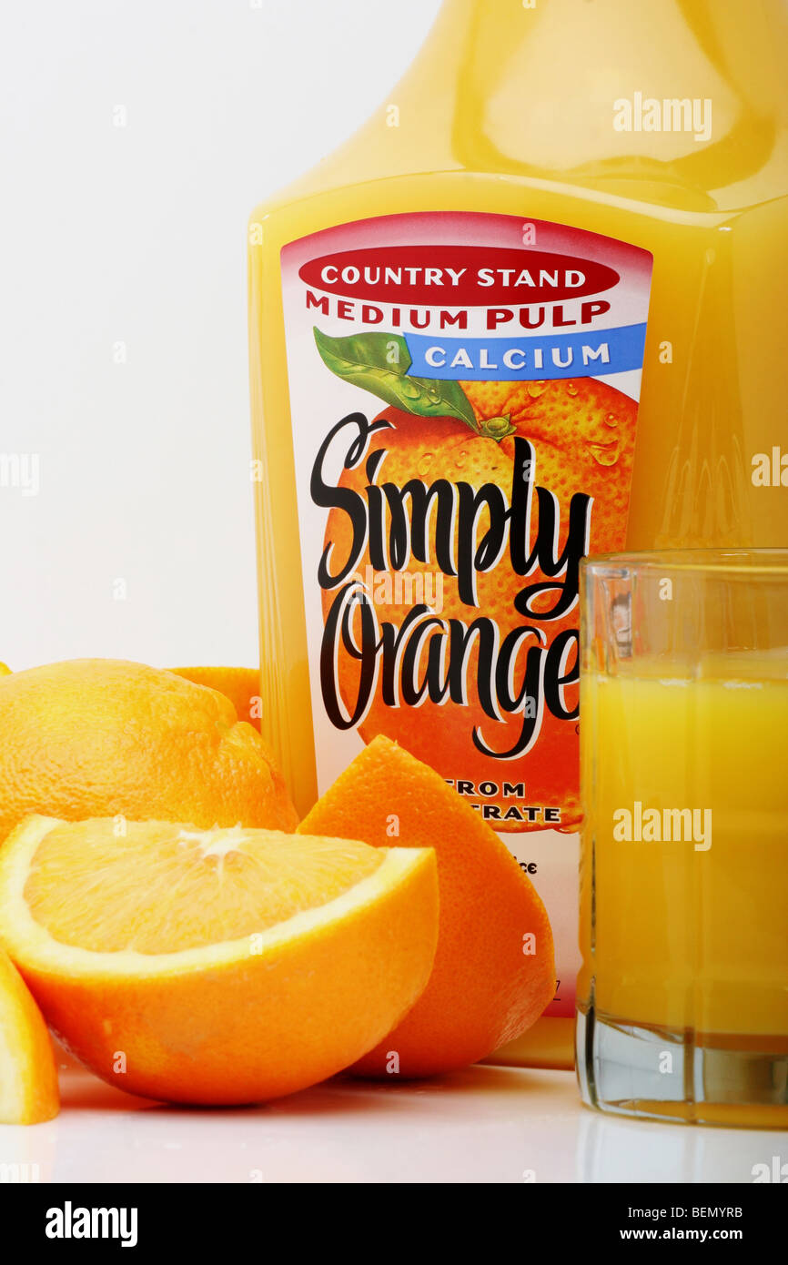 Simply orange juice in a plastic bottle and poured in a glass with ...