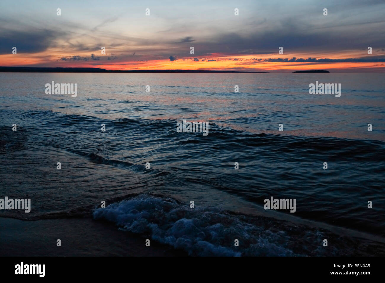 Lake Michigan at MI dramatic orange sunset sky over dark water ...