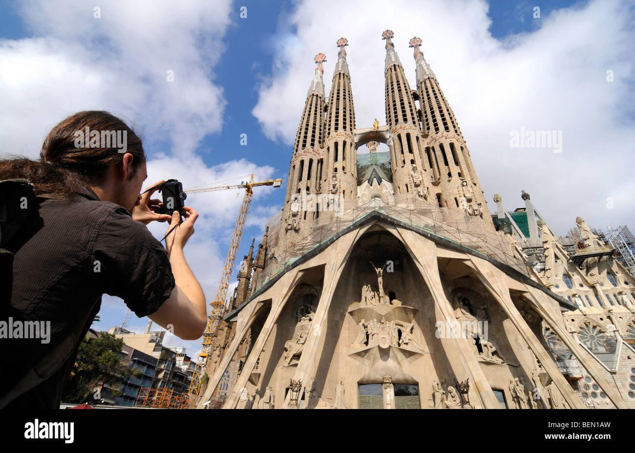 Tourist taking a photo of the Sagrada Familia, Gaudi's iconic giant ...