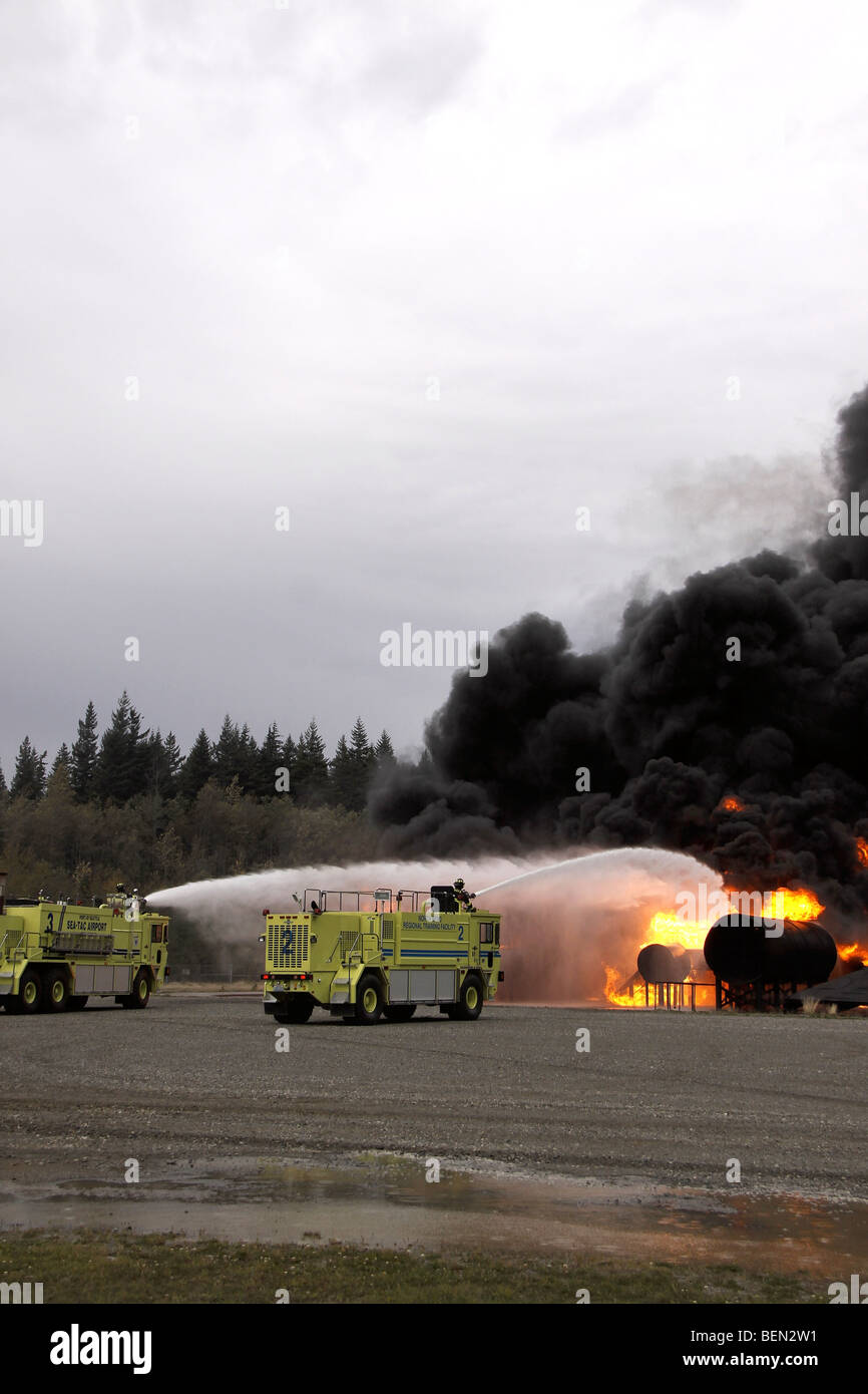 ARFF apparatus attacking an aircraft prop on fire at a training drill ...