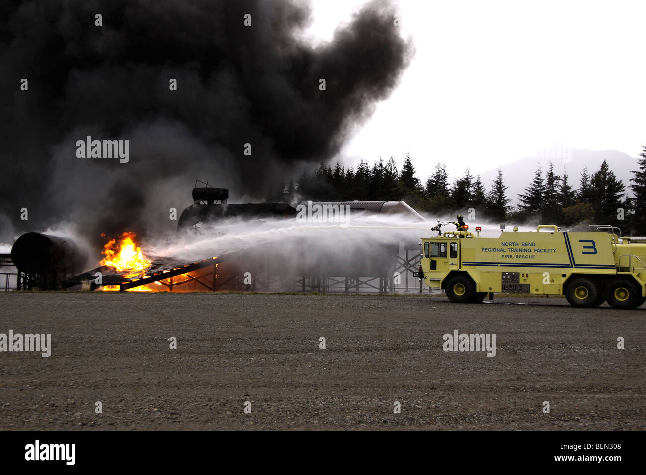 ARFF apparatus attacking an aircraft prop on fire at a training drill ...