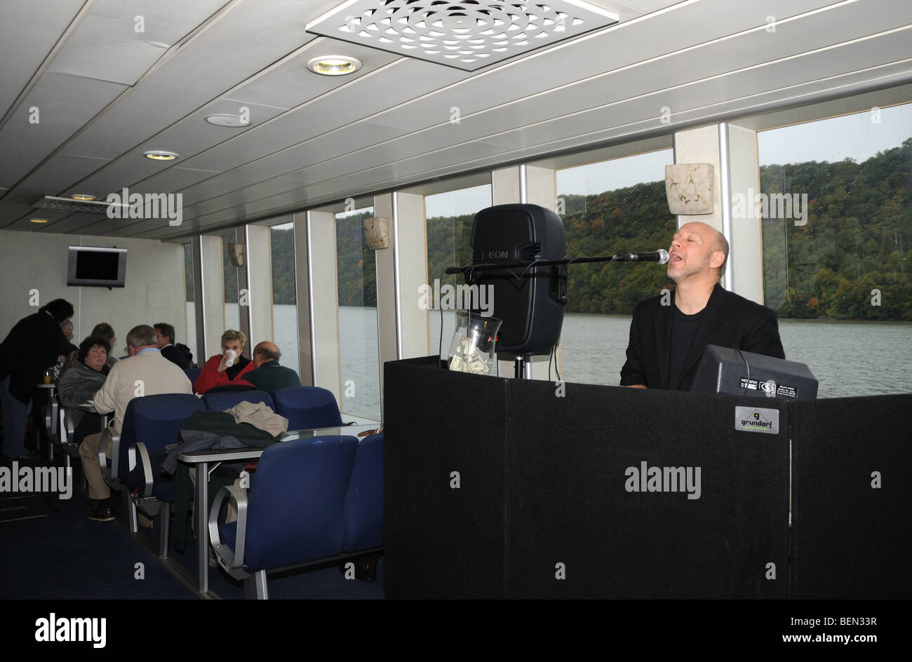 A singer entertains passengers aboard a cruise ship on the Hudson River ...