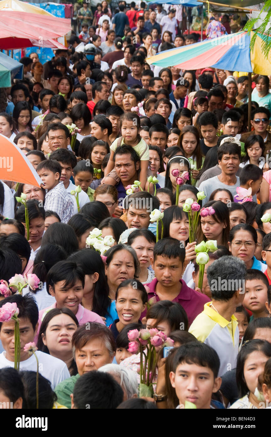 crowd with lotus flowers at the Rap Bua Lotus Throwing Festival in ...