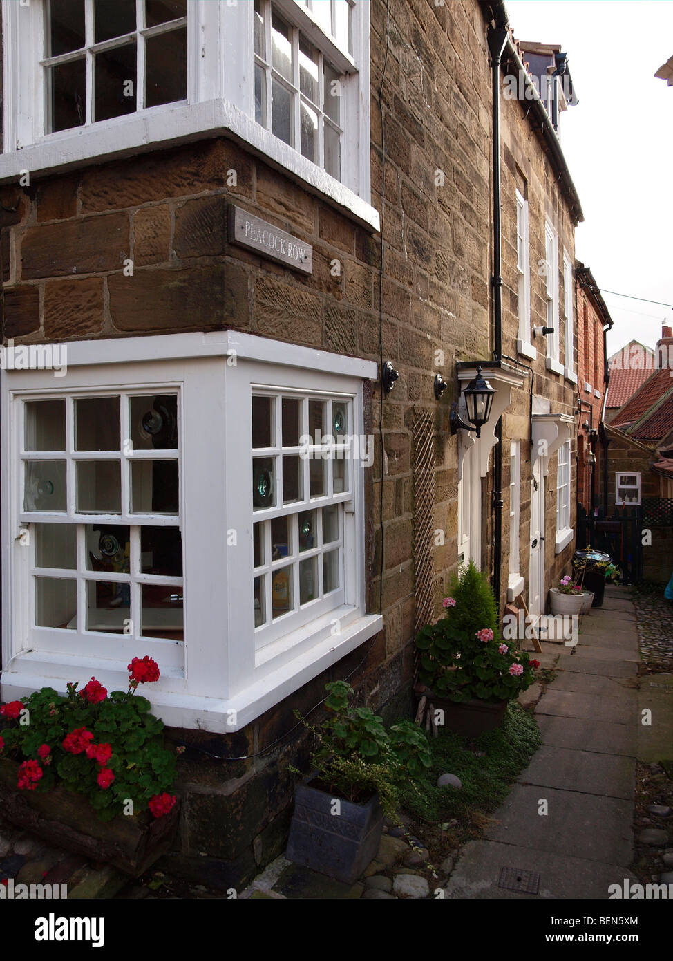 A stone cottage with unusual corner windows in Peacock Row in Robin ...