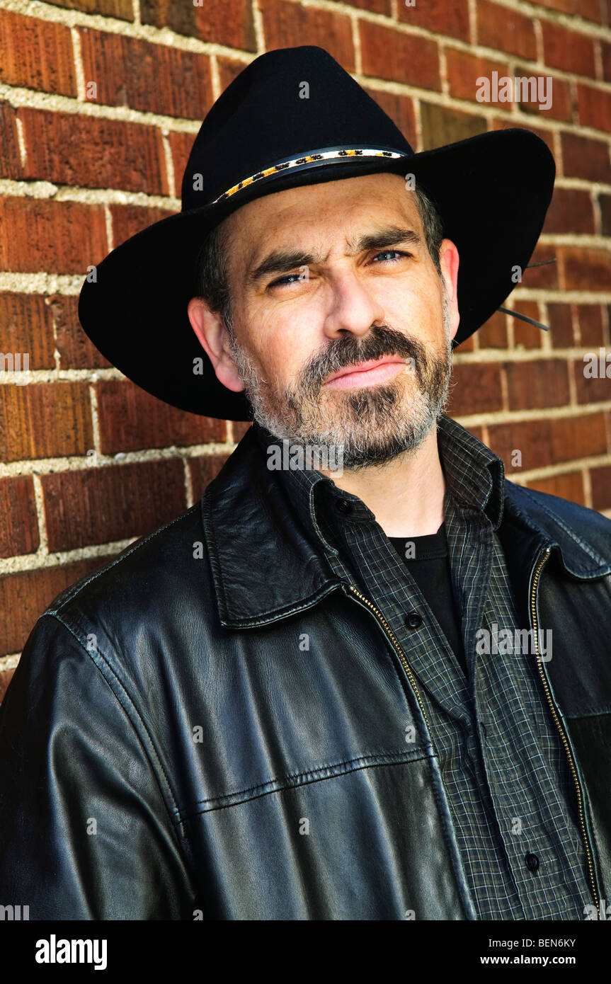 Man with beard in cowboy hat and leather jacket Stock Photo - Alamy