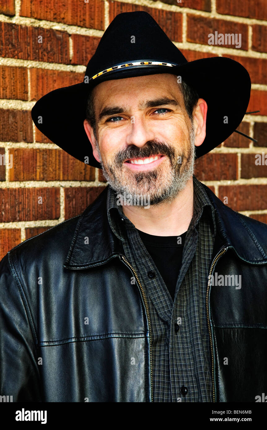 Man with beard in cowboy hat and leather jacket Stock Photo - Alamy