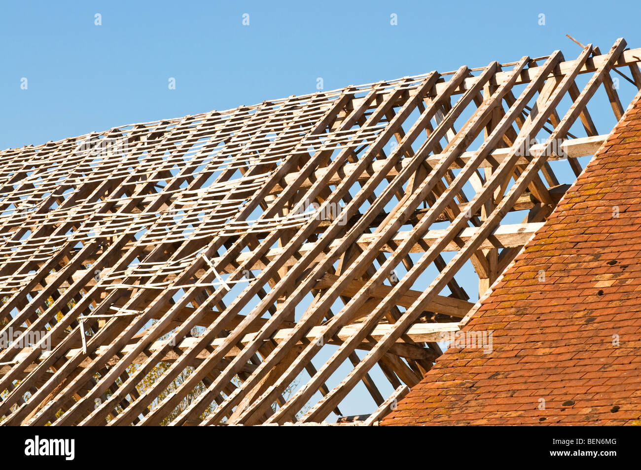 Storm damaged barn roof with tiles missing - France Stock Photo - Alamy