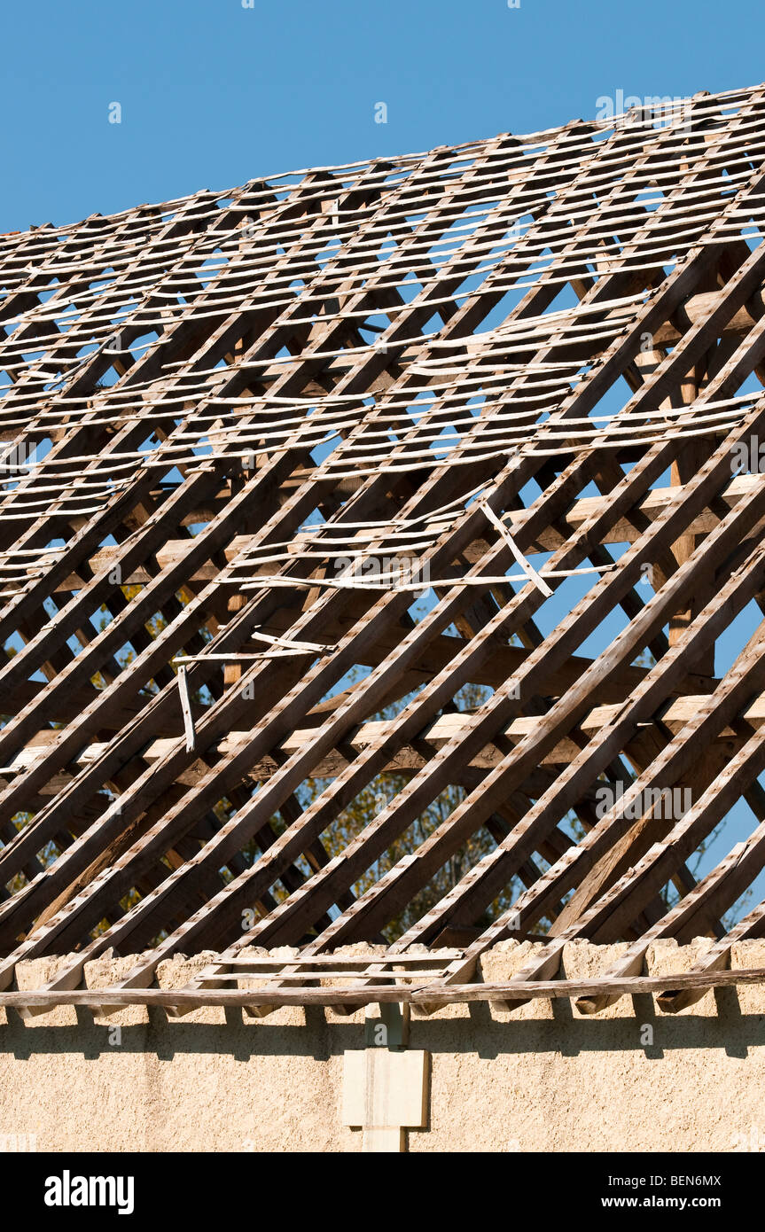 Storm damaged barn roof with tiles missing - France Stock Photo - Alamy