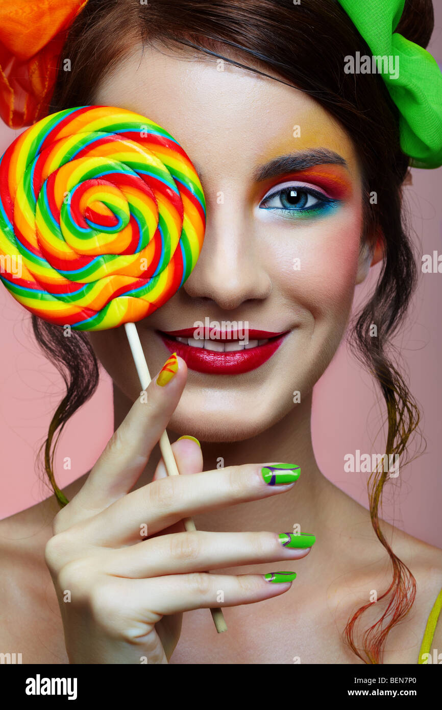 Happy girl in bright make-up with lollipop Stock Photo - Alamy