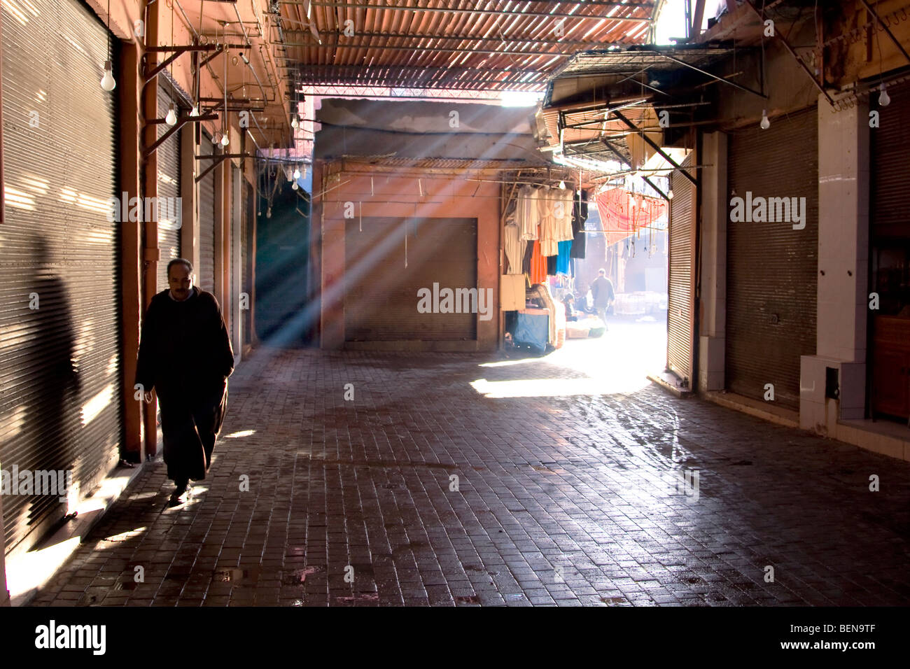 One man walk in the old smoky souk in Marrakech Medina. Morocco, North ...