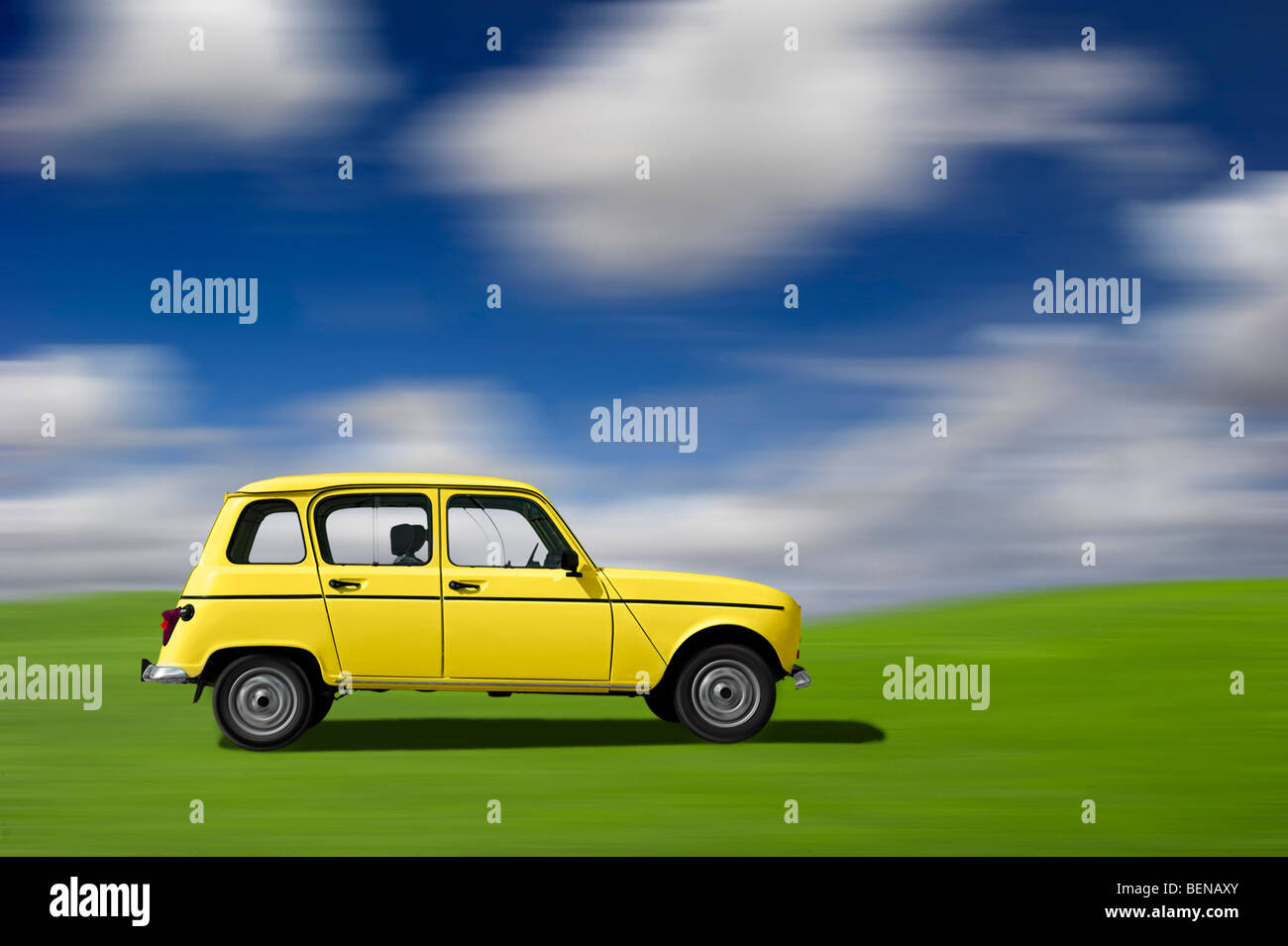 Yellow classic car at high speed in a green meadow (motion effect Stock ...