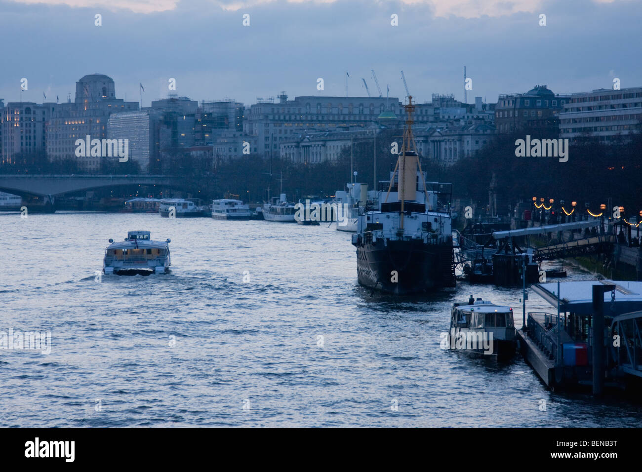 Thames Clipper boat glides up river past Victoria Embankment in London ...