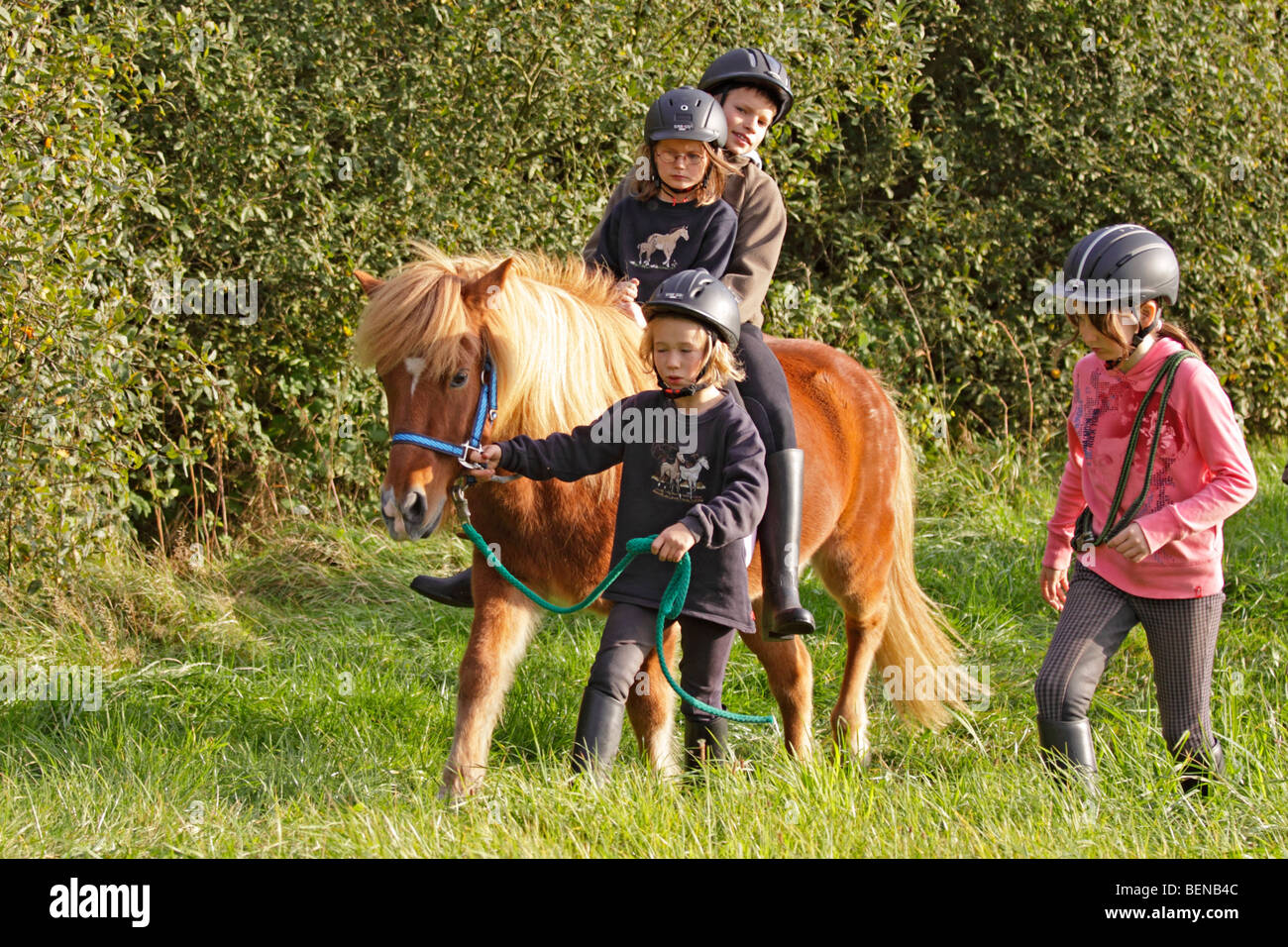 children riding a pony Stock Photo - Alamy