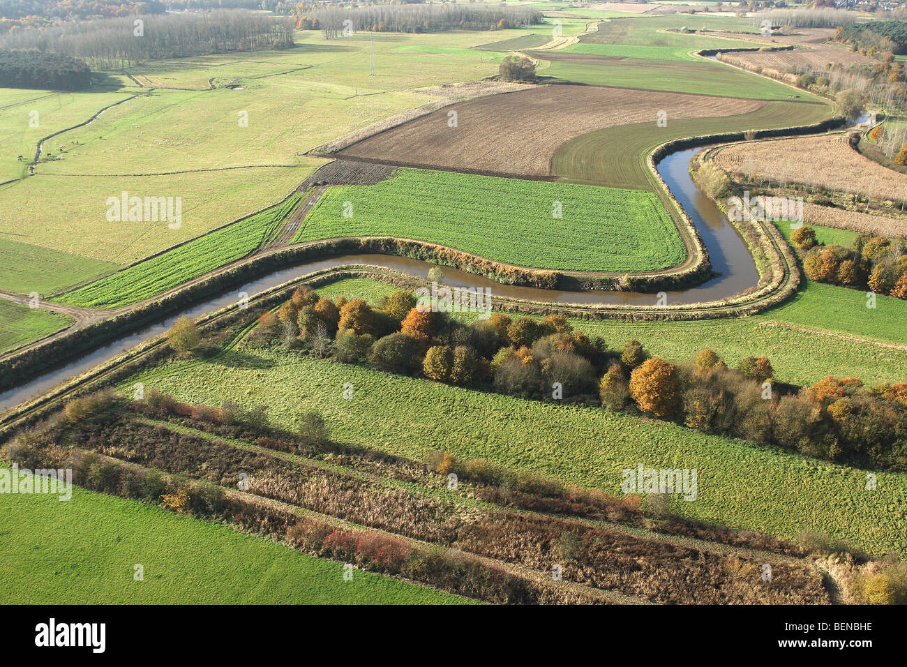 Fields, grasslands, forested area along river Demer from the air in ...