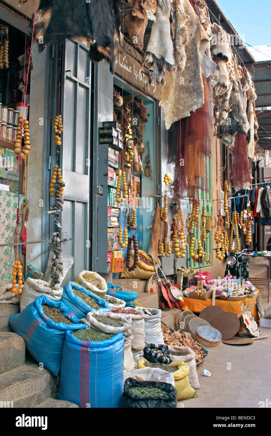 Goods and bags with herbs on display of traditional pharmacy ...