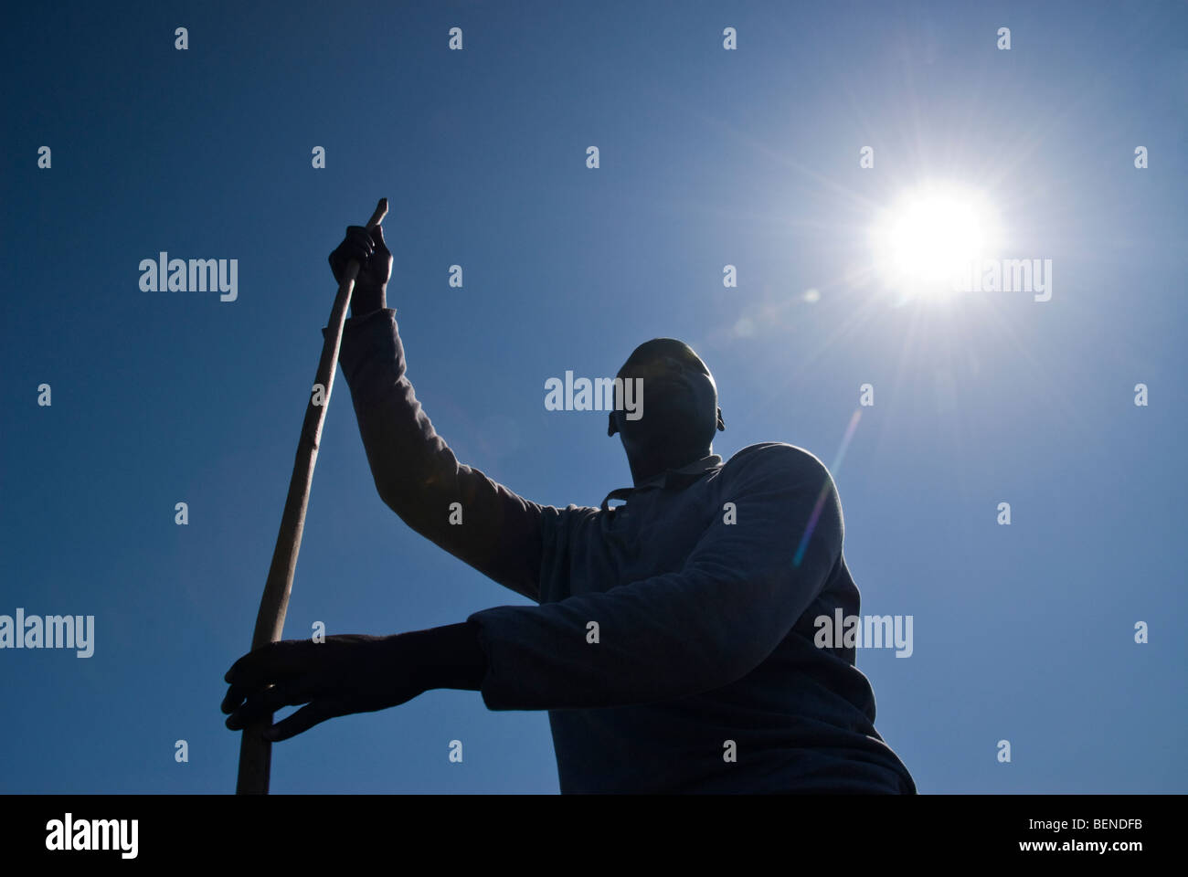 Mokoro poler´s silhouette against the sun. Okavango delta, Botswana ...