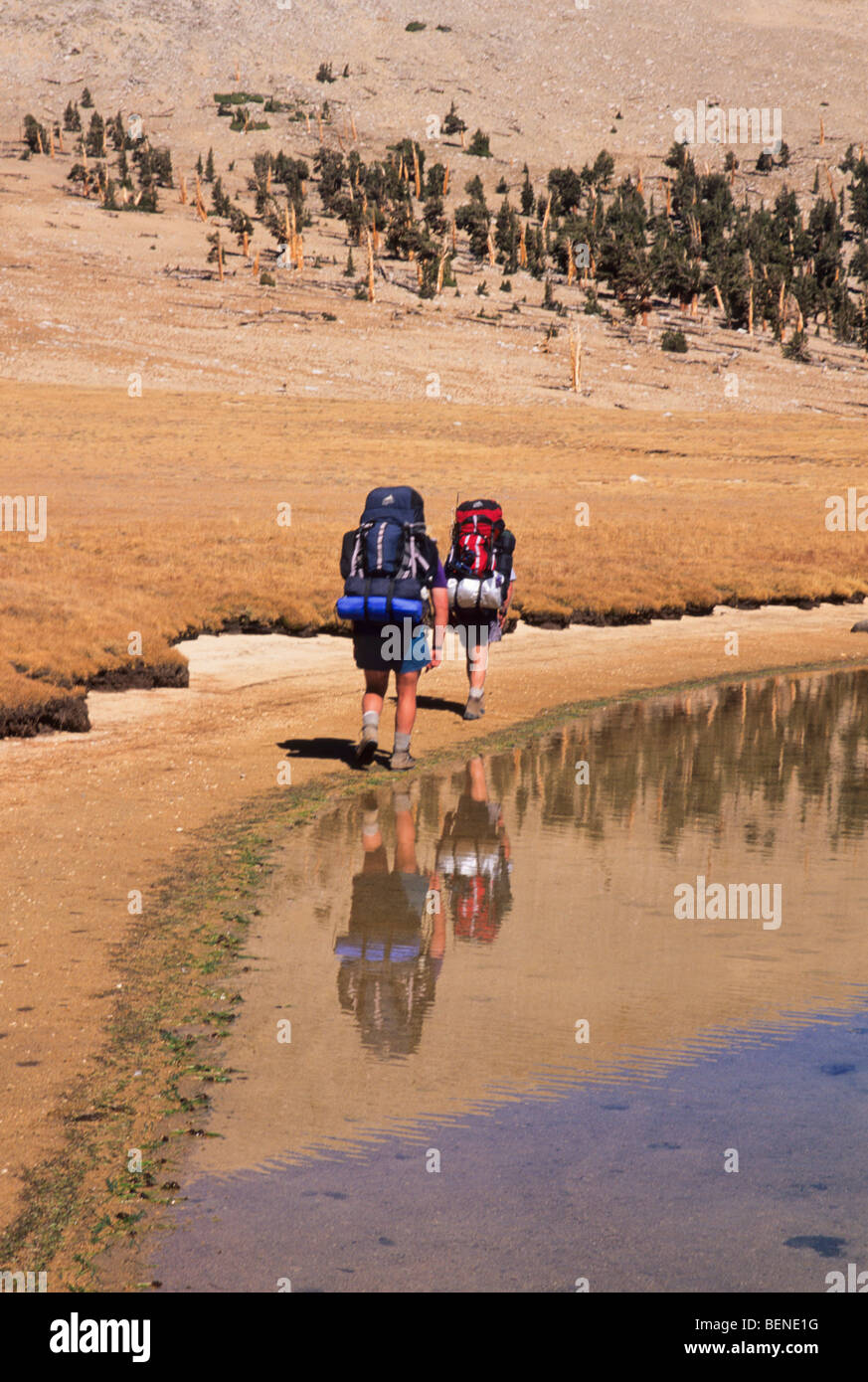 Men backpacking by lake Stock Photo - Alamy