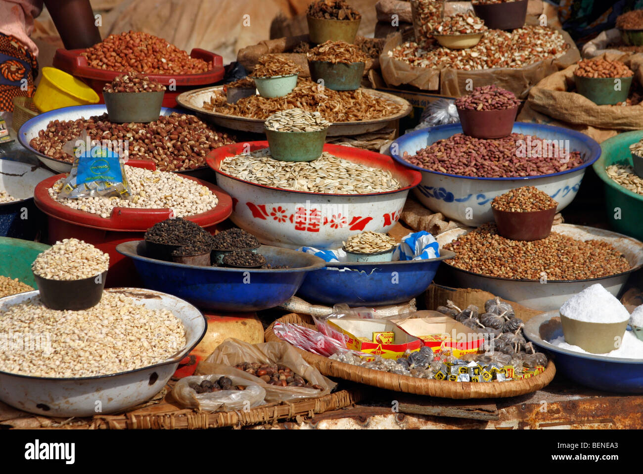 Basins and bowls with spices and food ingredients on display at market ...