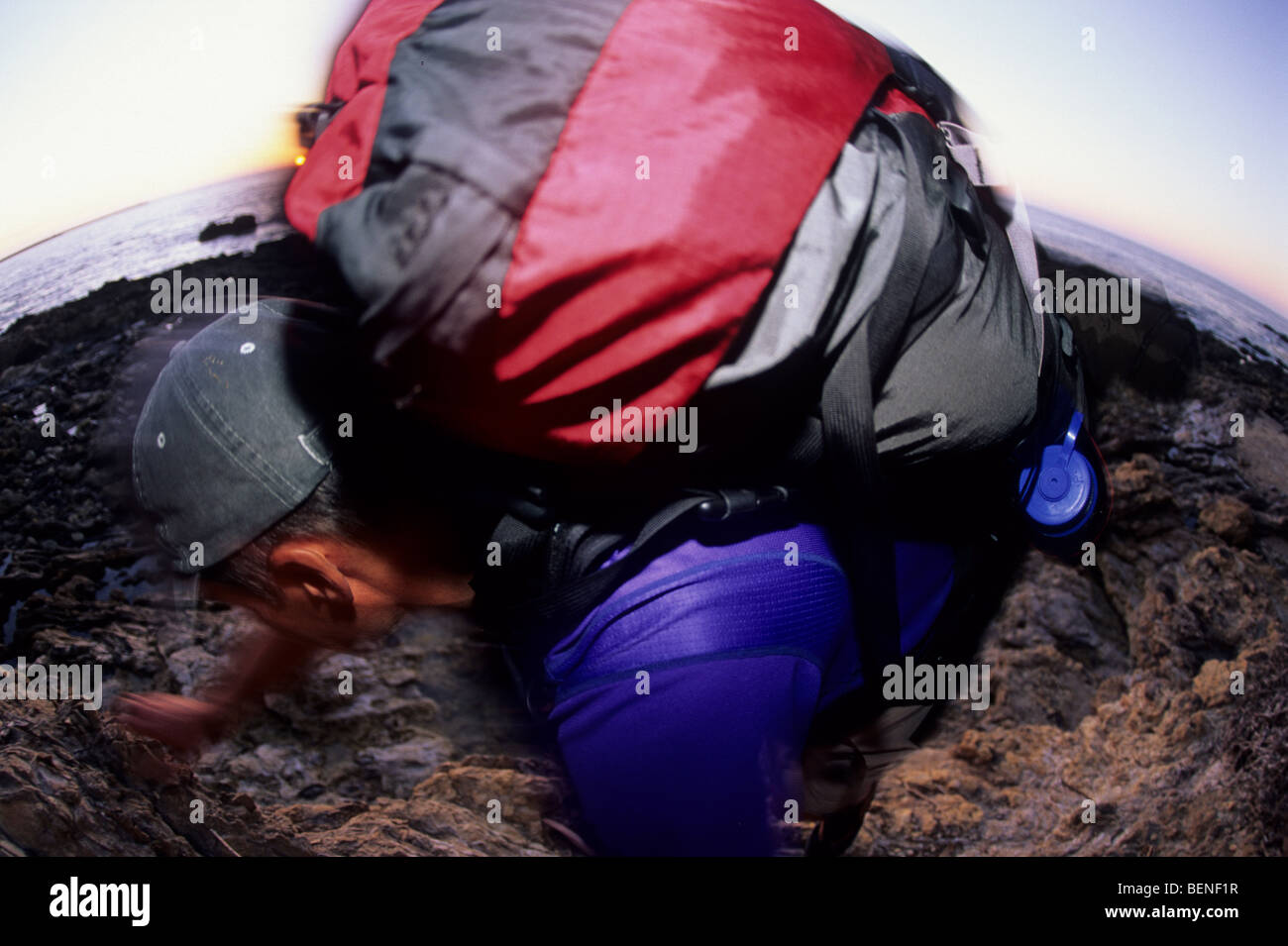 Man backpacking along coast Stock Photo - Alamy
