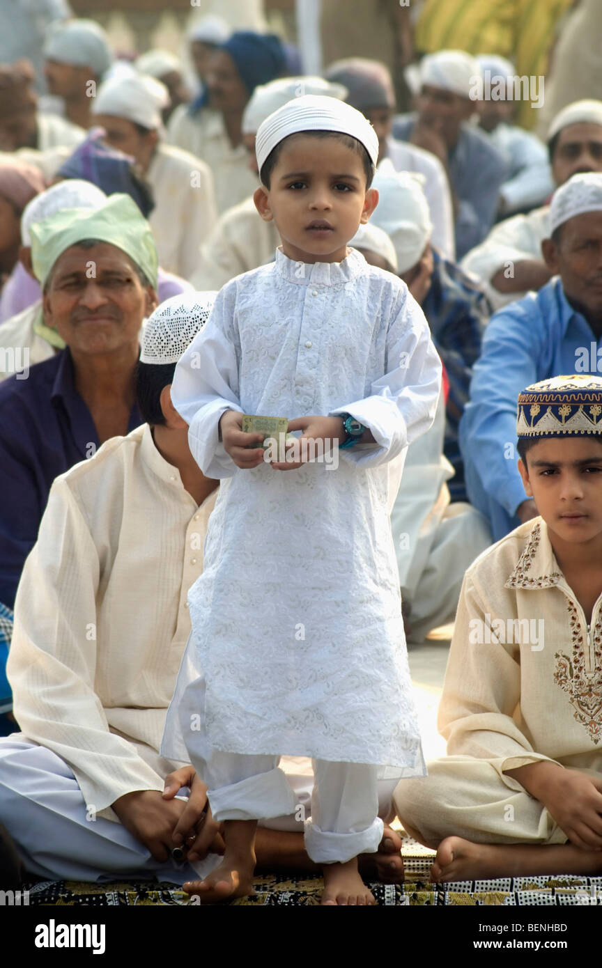 A Muslim boy standing with elders at the Id prayers at Red Road Kolkata ...