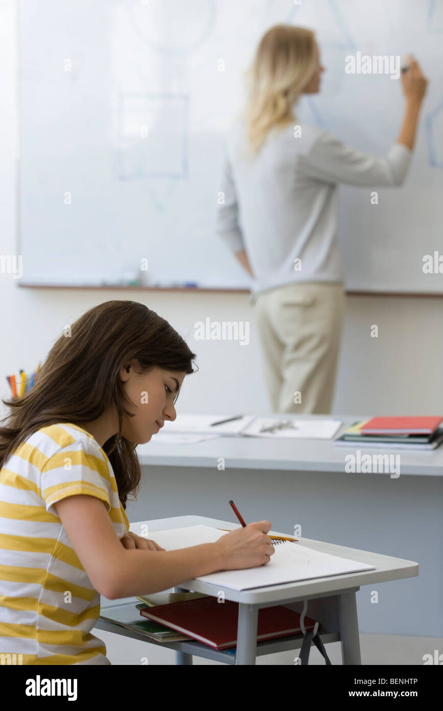 Two teenage students teacher desk hi-res stock photography and images ...