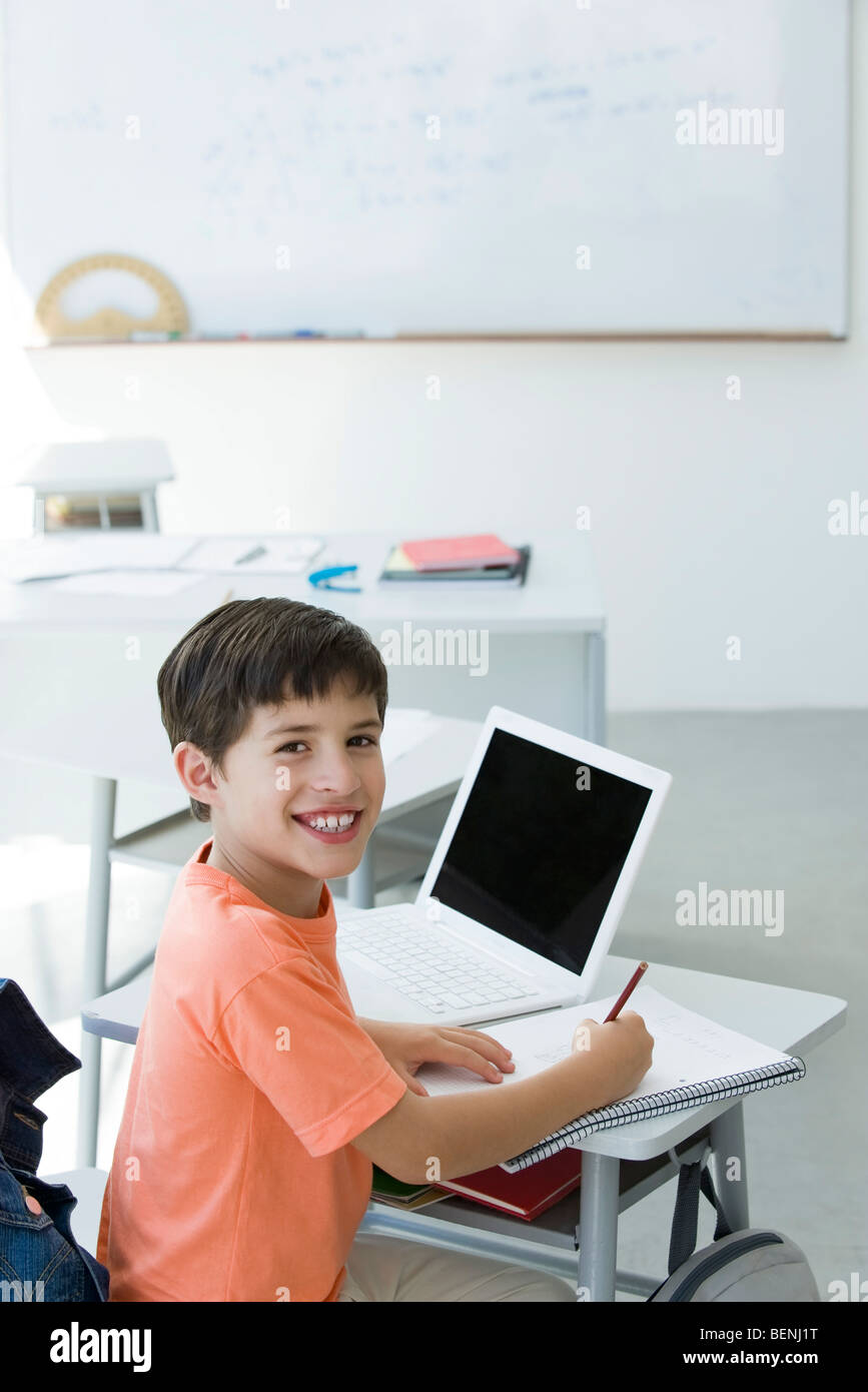 Elementary school student doing classwork, smiling at camera Stock ...