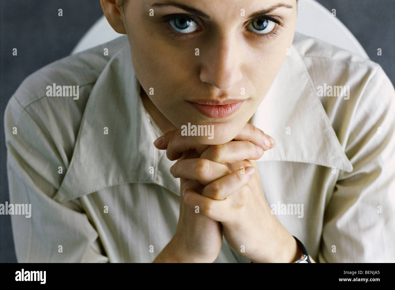 Woman sitting clasped hands cropped hi-res stock photography and images - Alamy