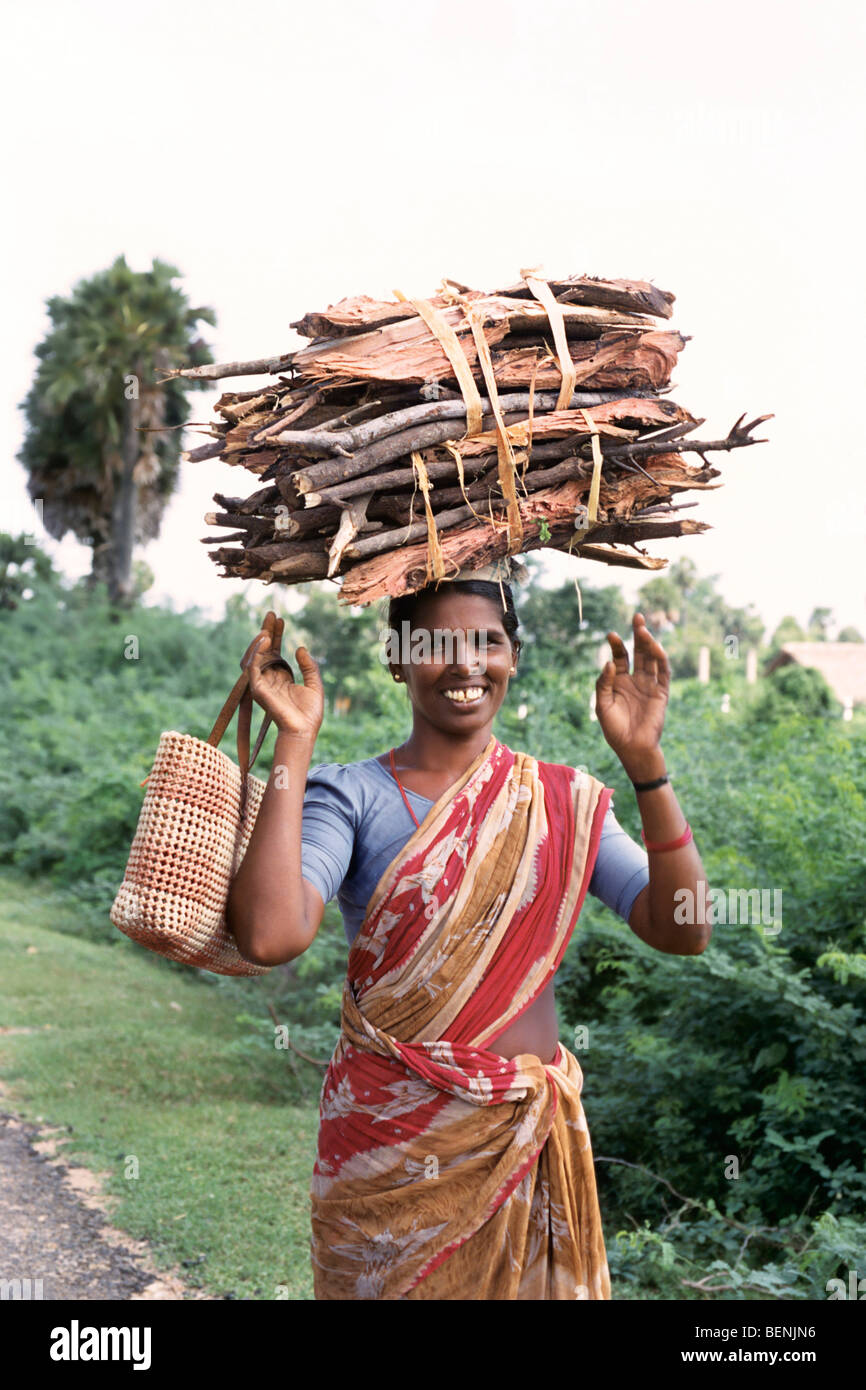 Woman carrying fire wood on hi-res stock photography and images - Alamy
