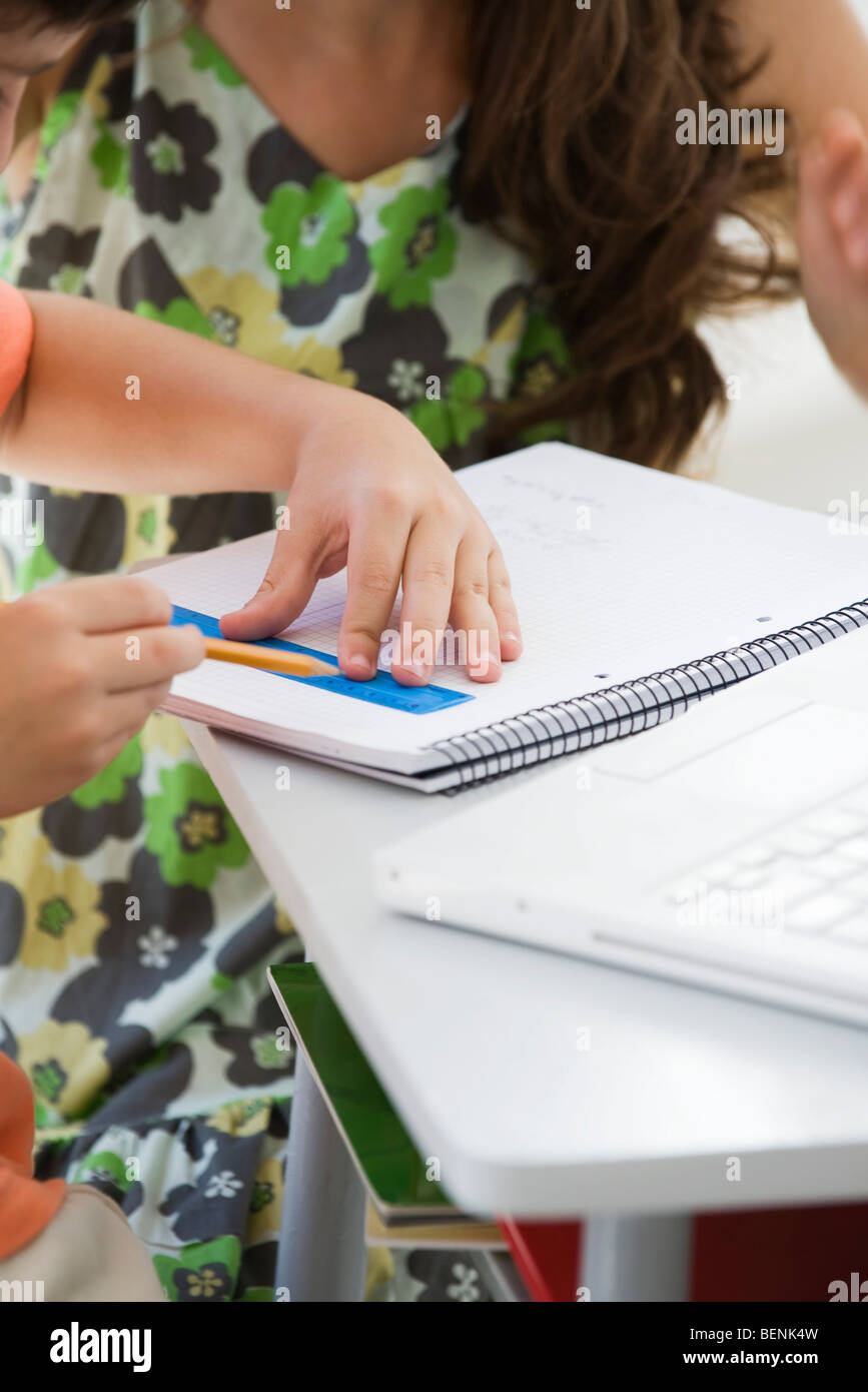 Tutor working with elementary school student Stock Photo - Alamy