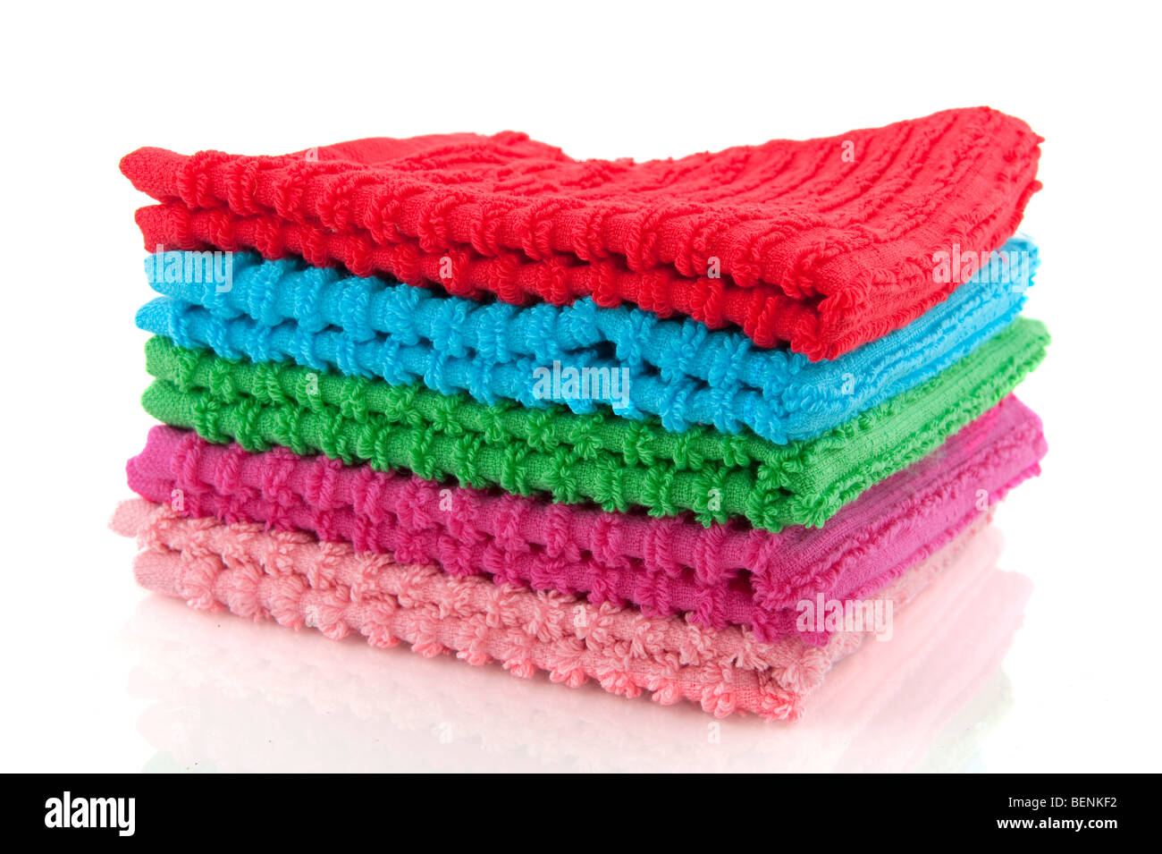 Folded colorful clothes stacked and isolated over white Stock Photo - Alamy