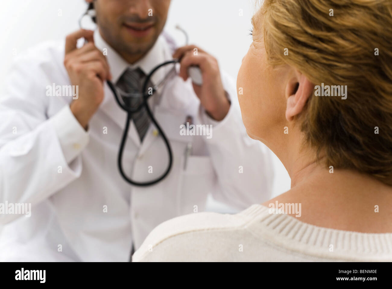 Doctor preparing to examine patient using stethoscope Stock Photo - Alamy