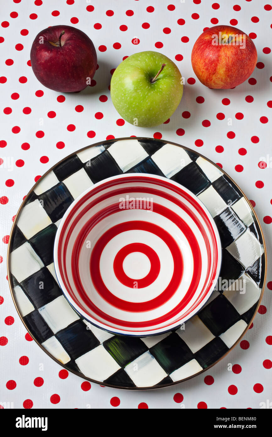 Three apples and bowl with plate Stock Photo - Alamy