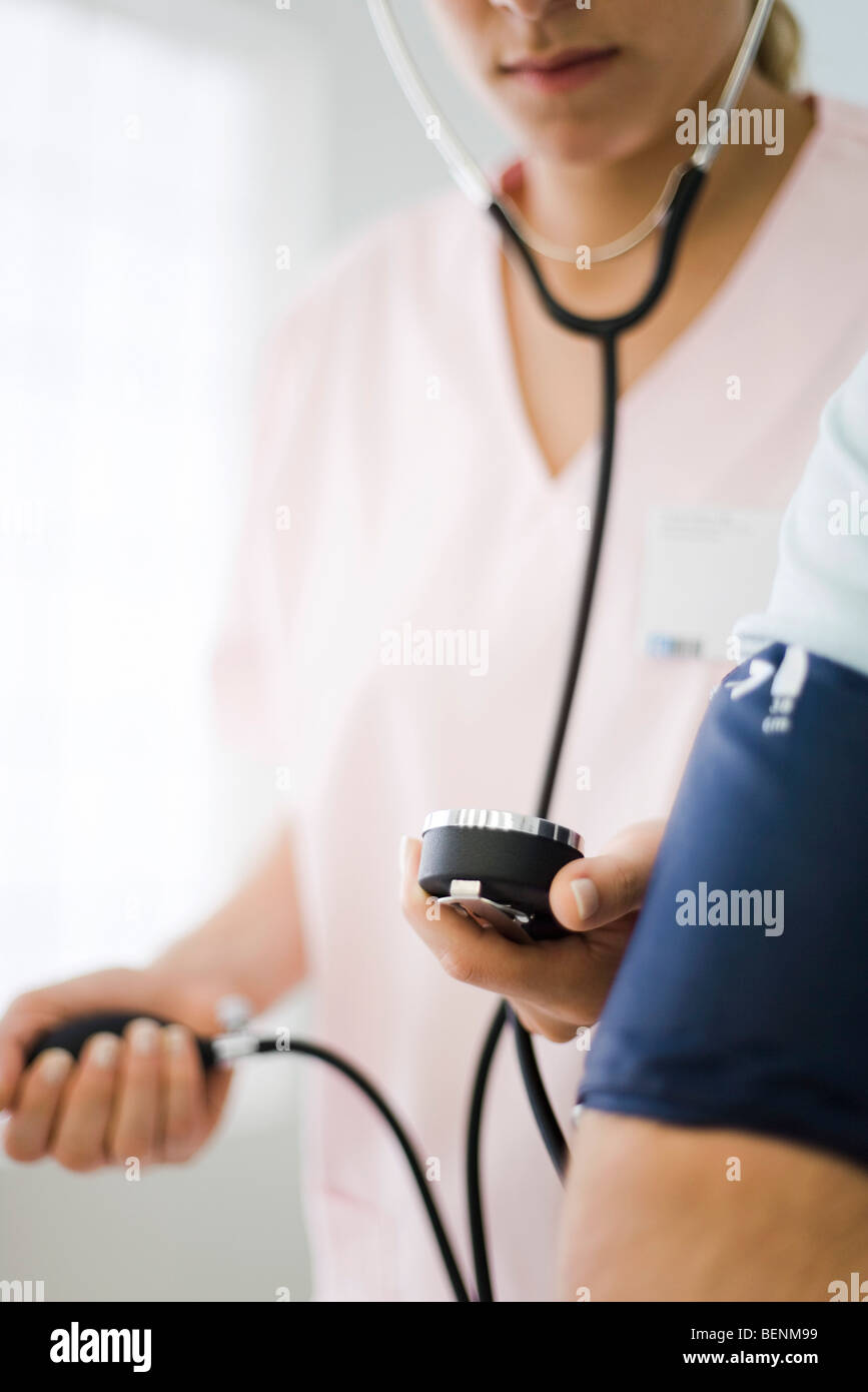 Nurse checking patient's blood pressure, cropped Stock Photo - Alamy