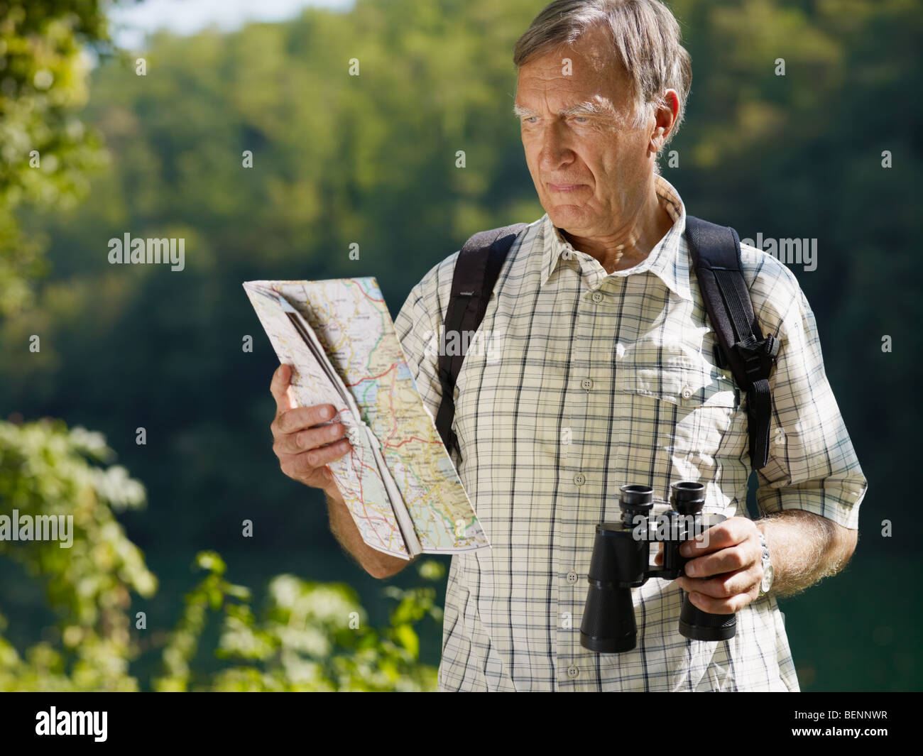 senior hiker holding map and binoculars. Copy space Stock Photo - Alamy
