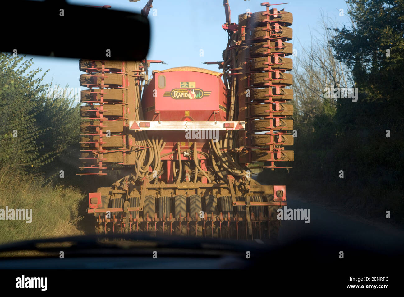 Driving behind farm vehicle on country road Stock Photo - Alamy