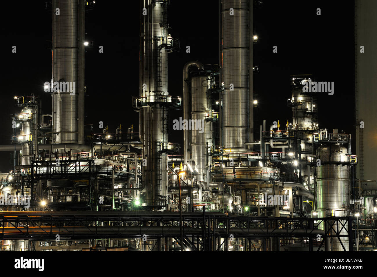 Refinery chimneys of petrochemical industry illuminated at night Stock ...