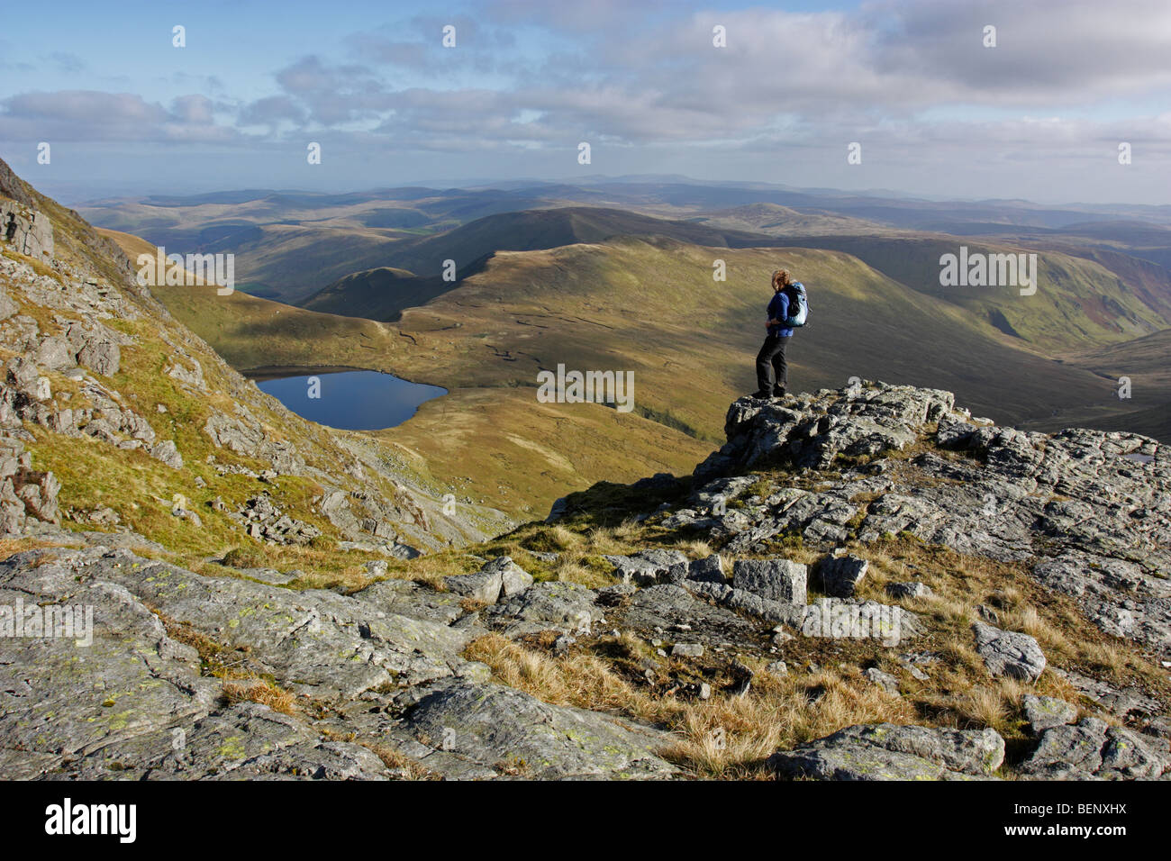 A female hill walker admires the view from Aran Fawddwy in Snowdonia ...