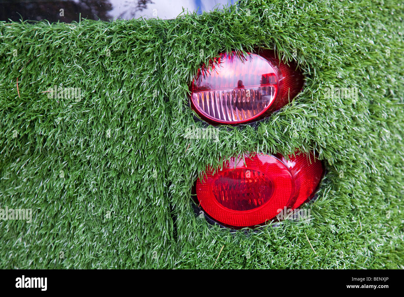 Rear light cluster of a Smart car covered in artificial grass London UK ...
