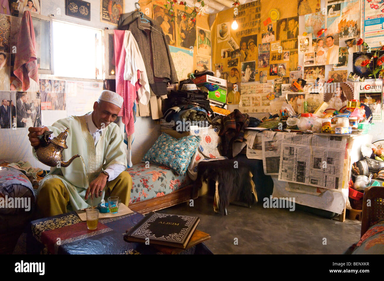 A poor Moroccan man pours tea in his basic one roomed rooftop ...