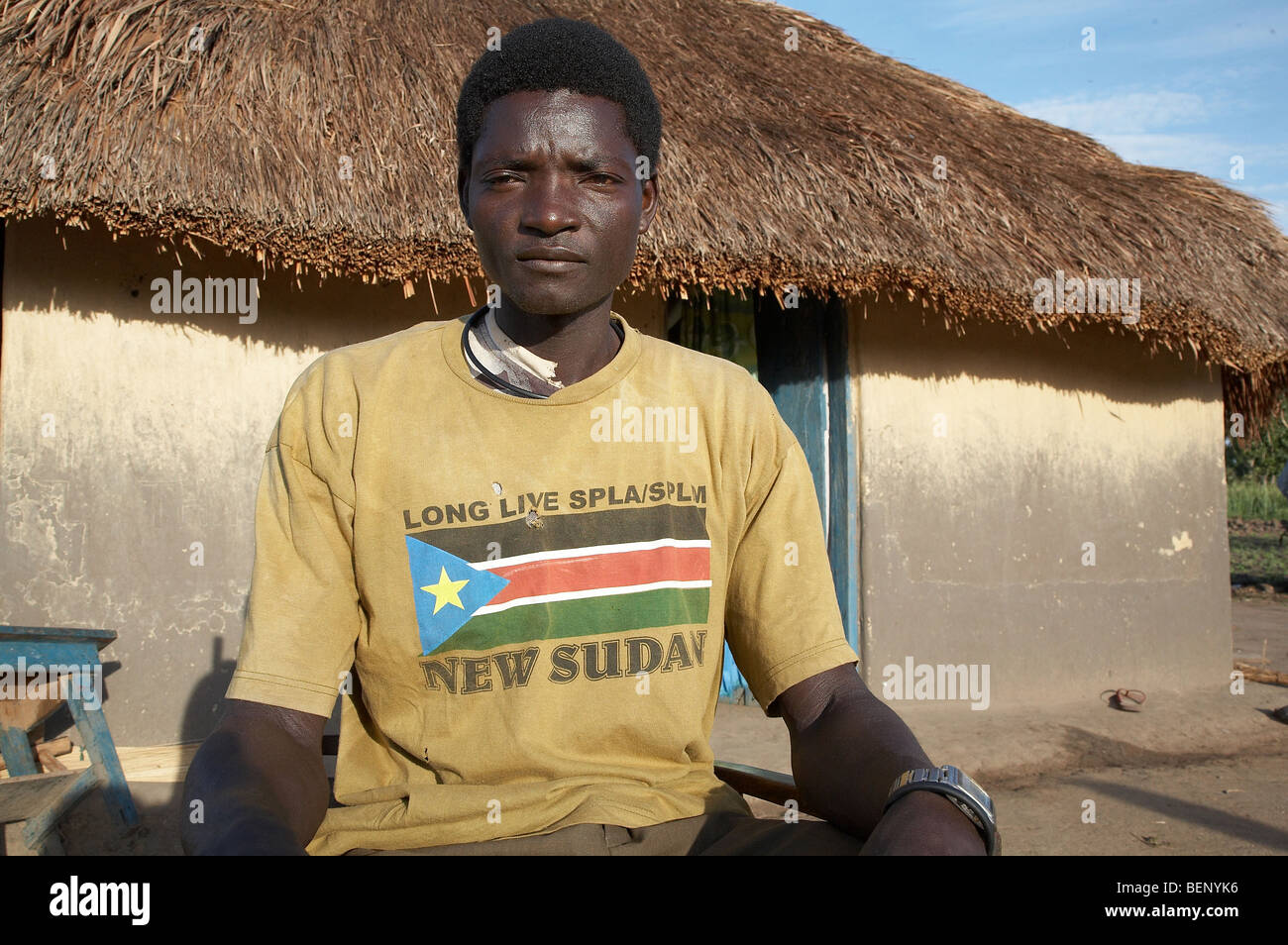 SOUTH SUDAN Early morning scene on a farm homestead of Yei. Young man ...